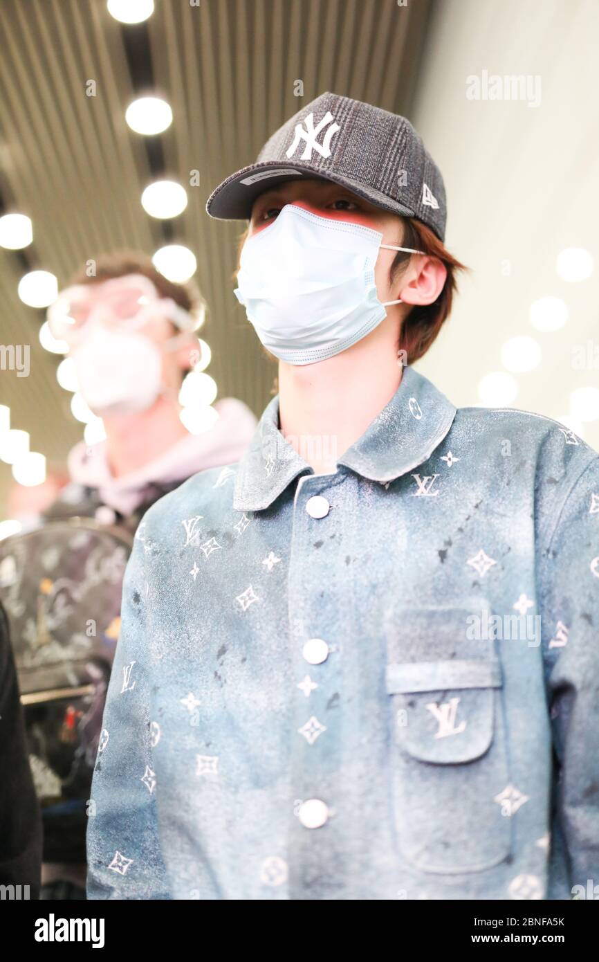 Chinese singer Ling Chao arrives at a Beijing airport before departure ...