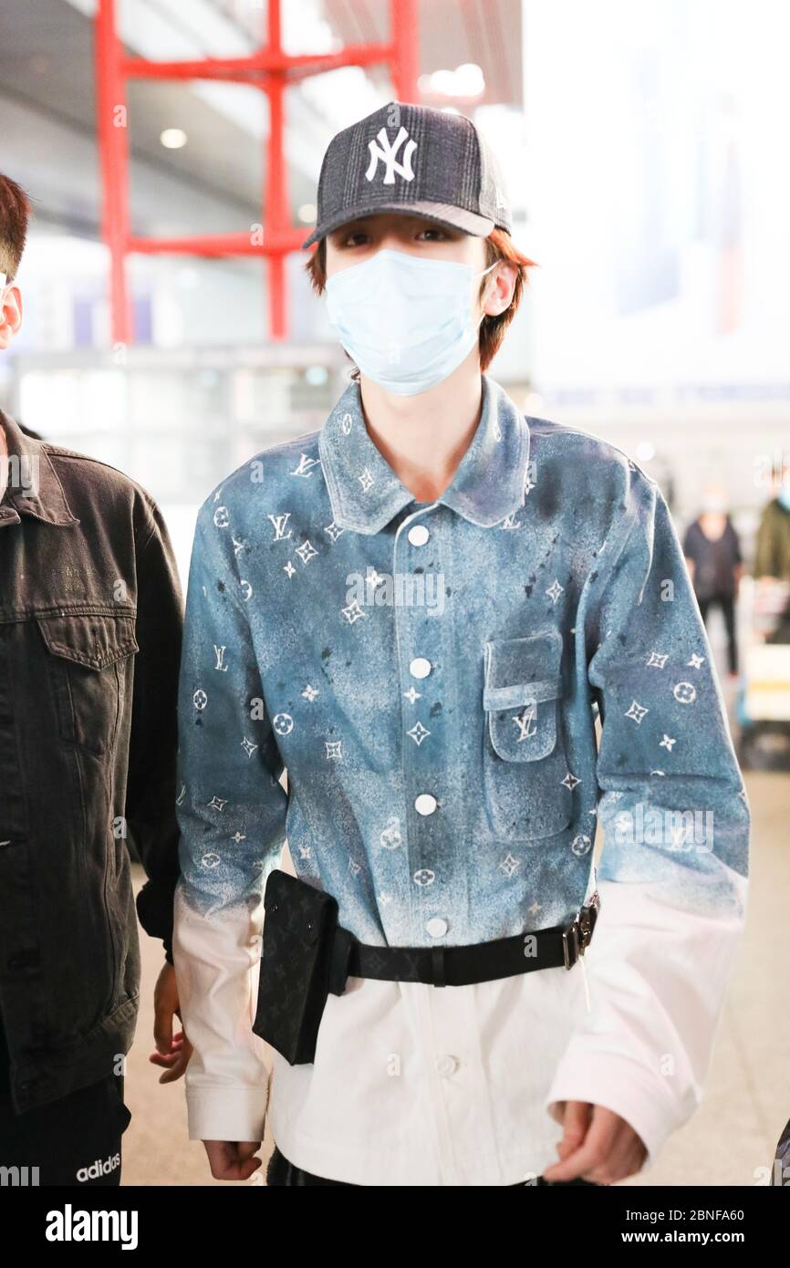 Chinese singer Ling Chao arrives at a Beijing airport before departure ...