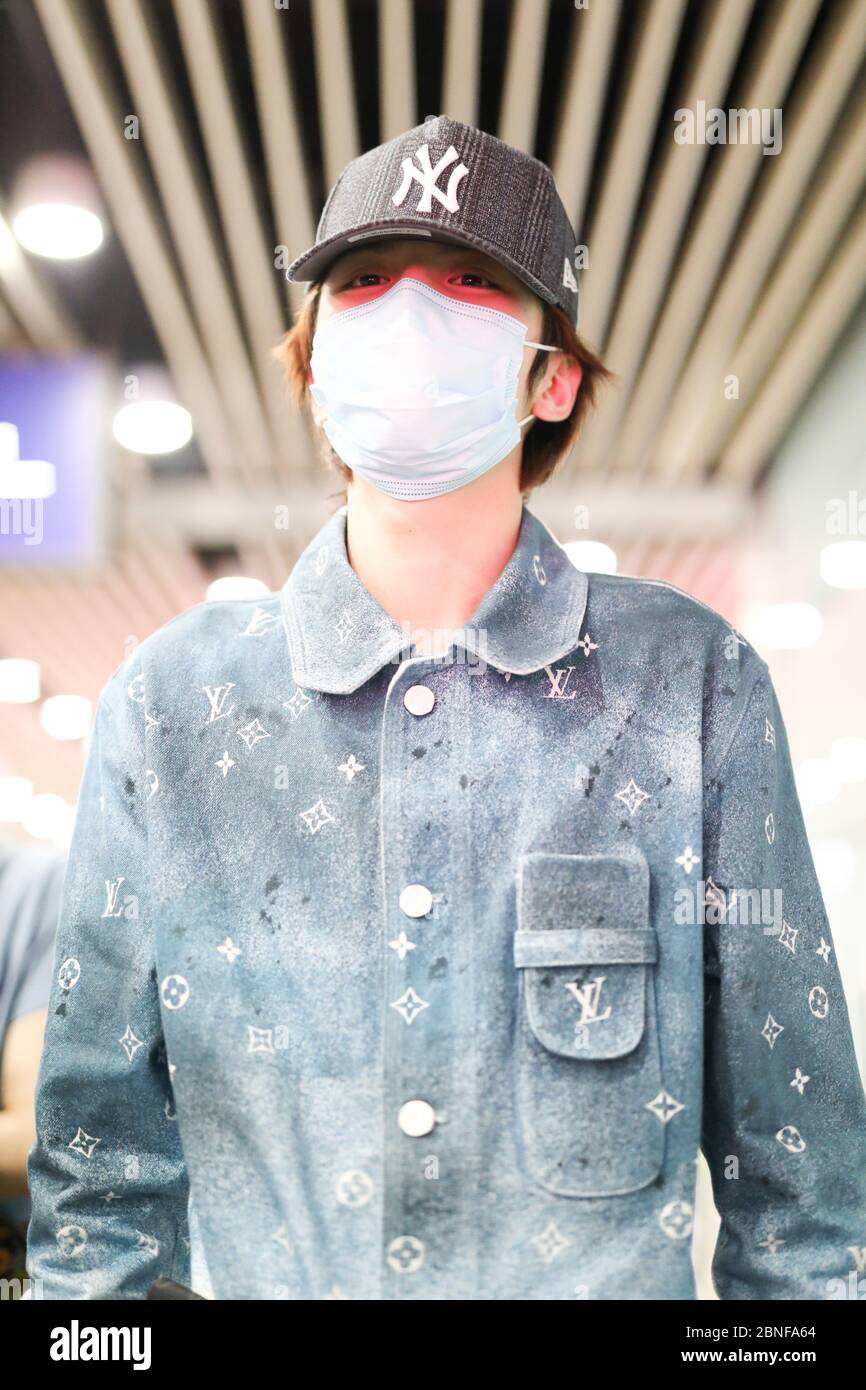 Chinese singer Ling Chao arrives at a Beijing airport before departure ...