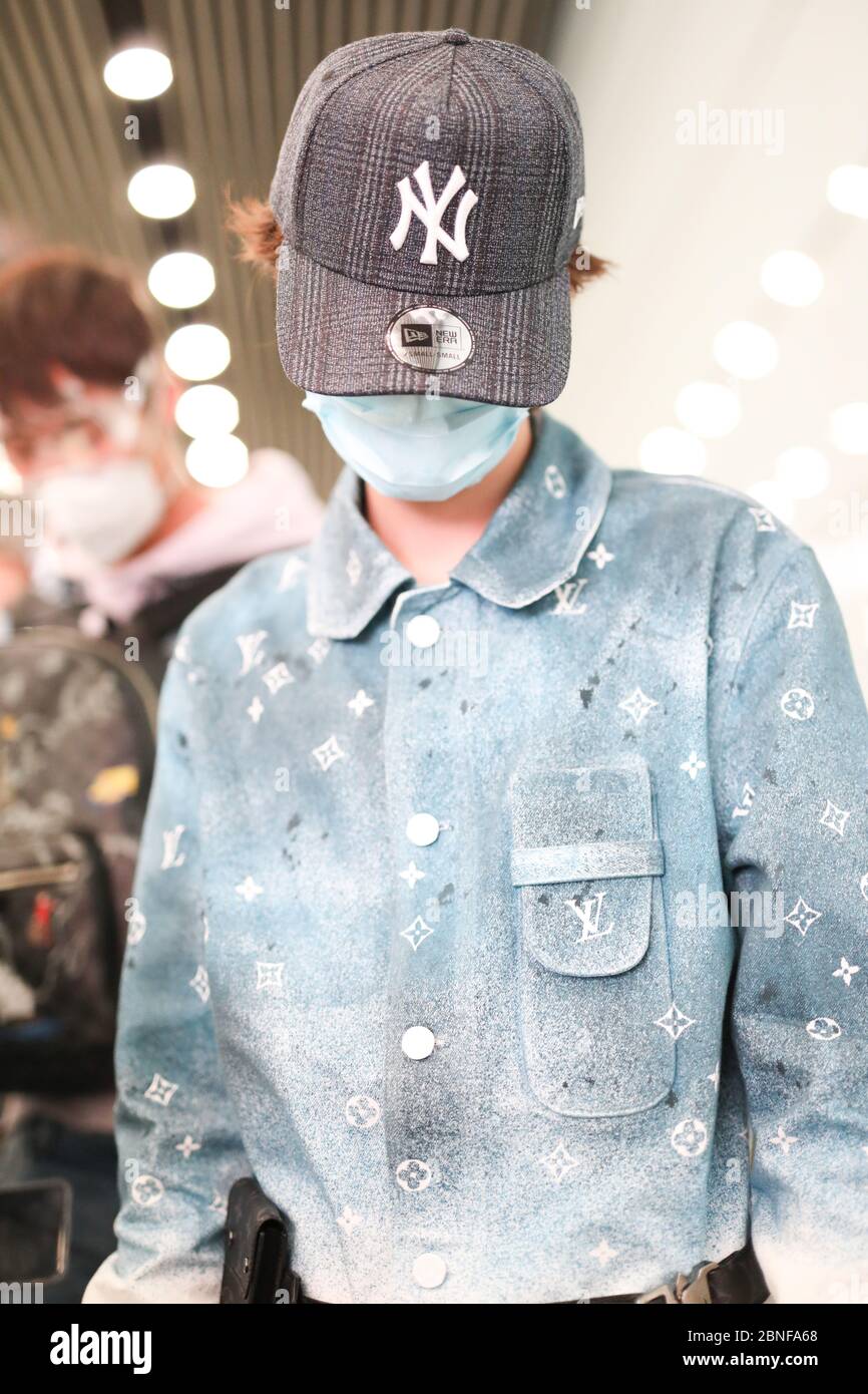 Chinese singer Ling Chao arrives at a Beijing airport before departure ...