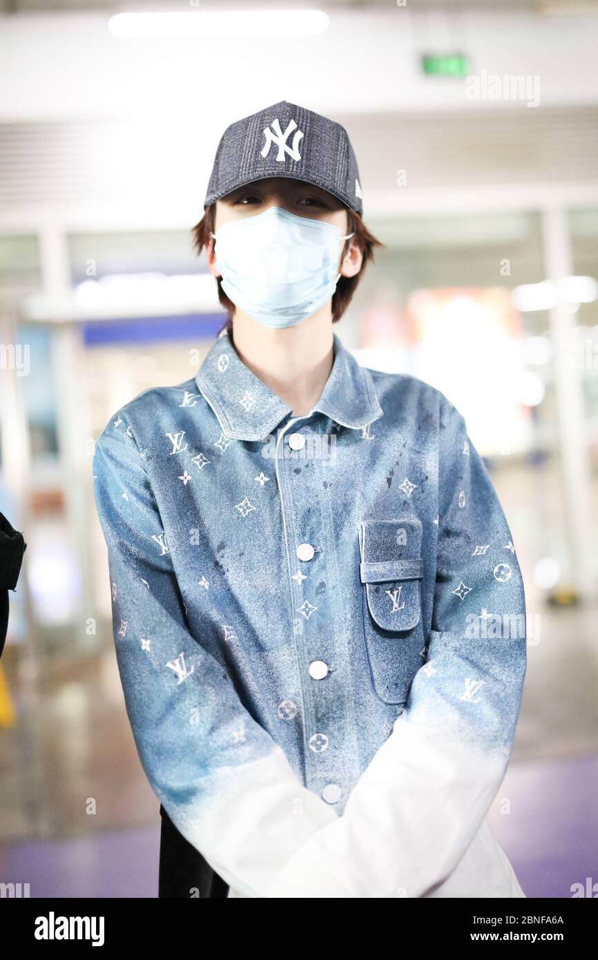 Chinese singer Ling Chao arrives at a Beijing airport before departure ...