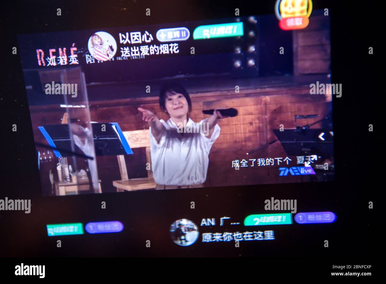 In this unlocated photo, a fan watches a livestream concert of Chinese ...