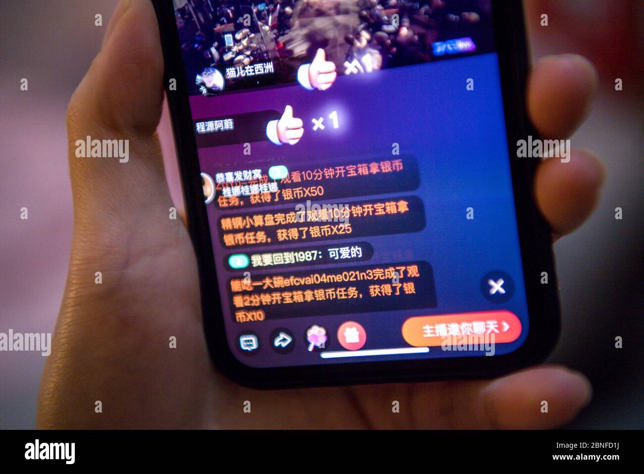 In this unlocated photo, a fan watches a livestream concert of Chinese ...