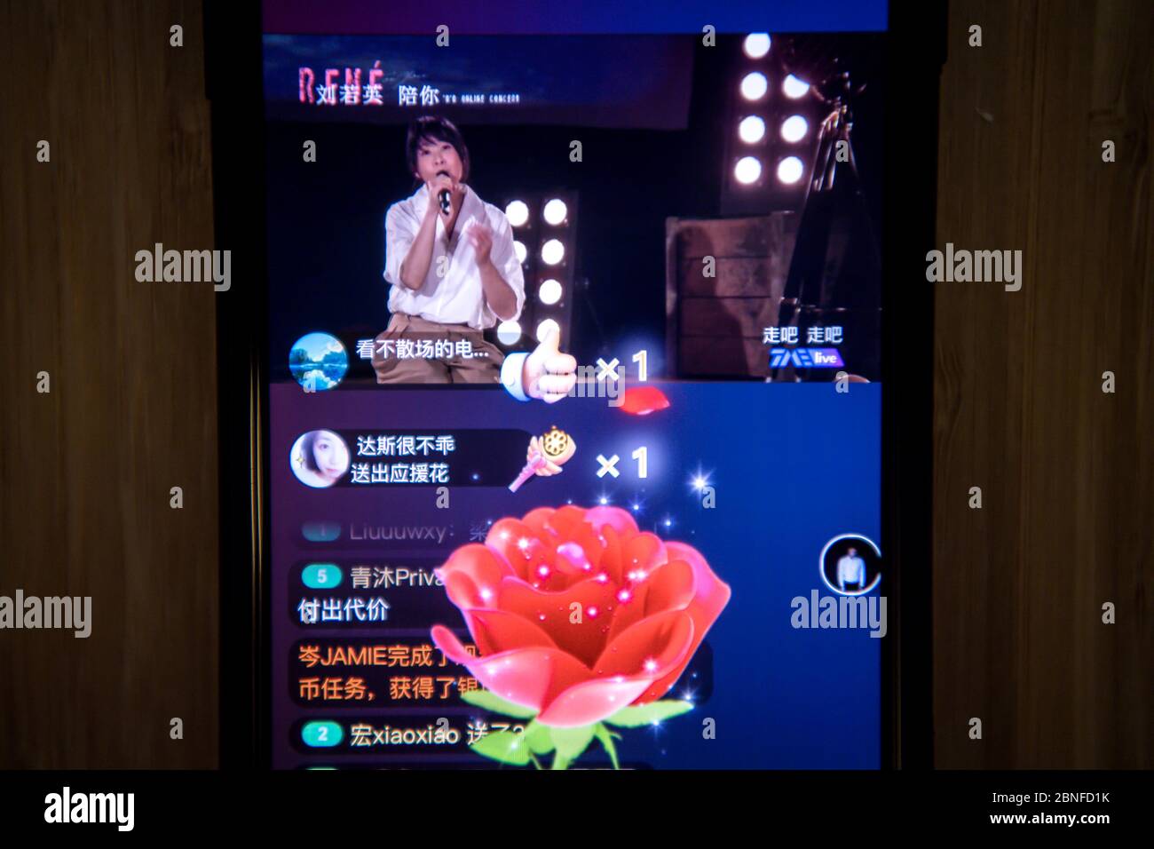In this unlocated photo, a fan watches a livestream concert of Chinese ...