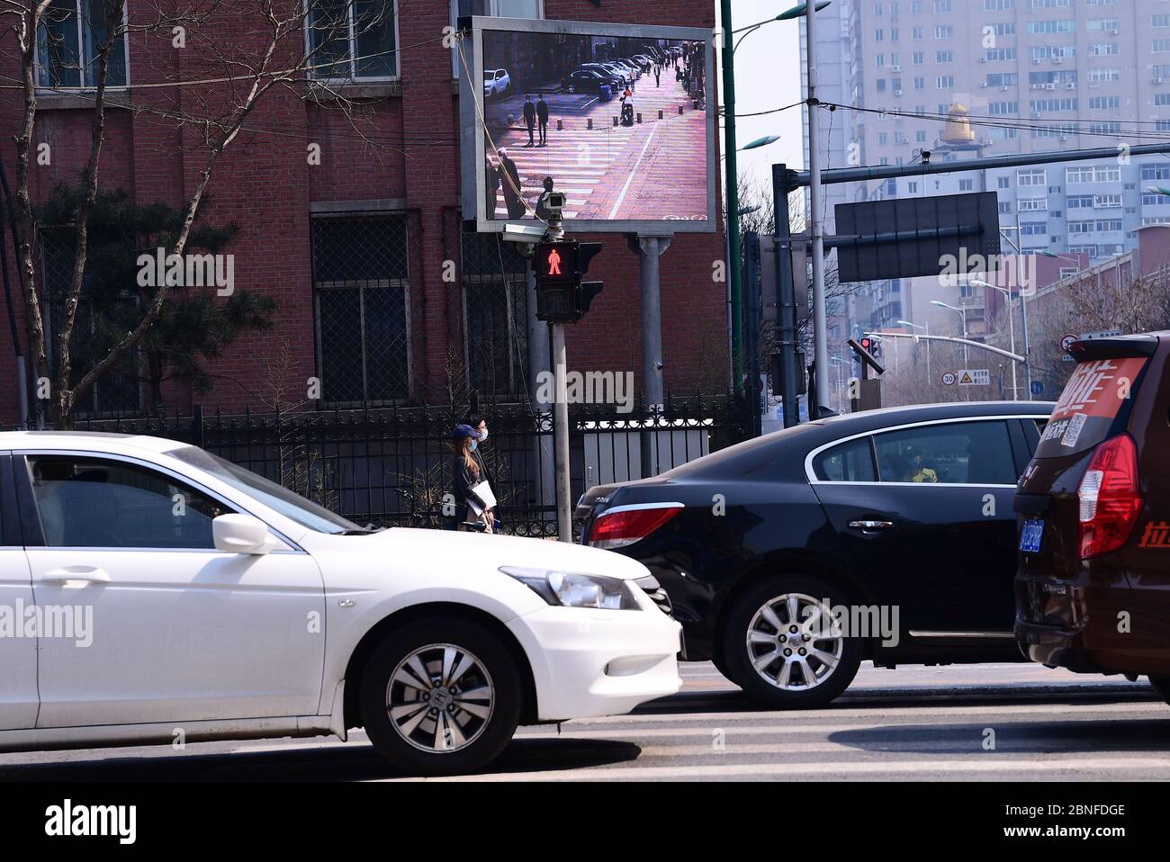 A large screen is deployed near crosswalk to show videos in which ...