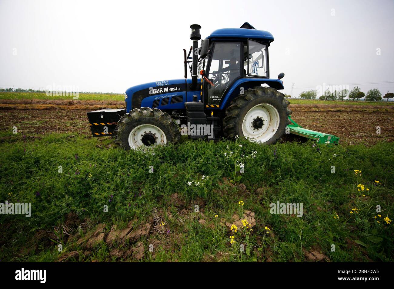 Agricultural machines take the chance of spring farming, working in the ...