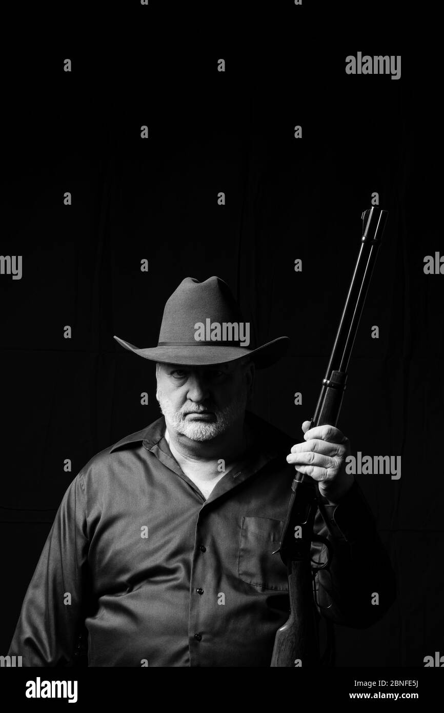 Cowboy with rifle hi-res stock photography and images - Alamy