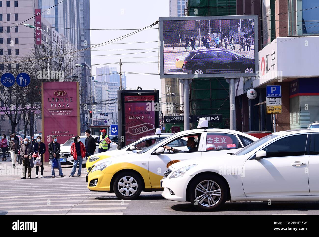 A large screen is deployed near crosswalk to show videos in which ...