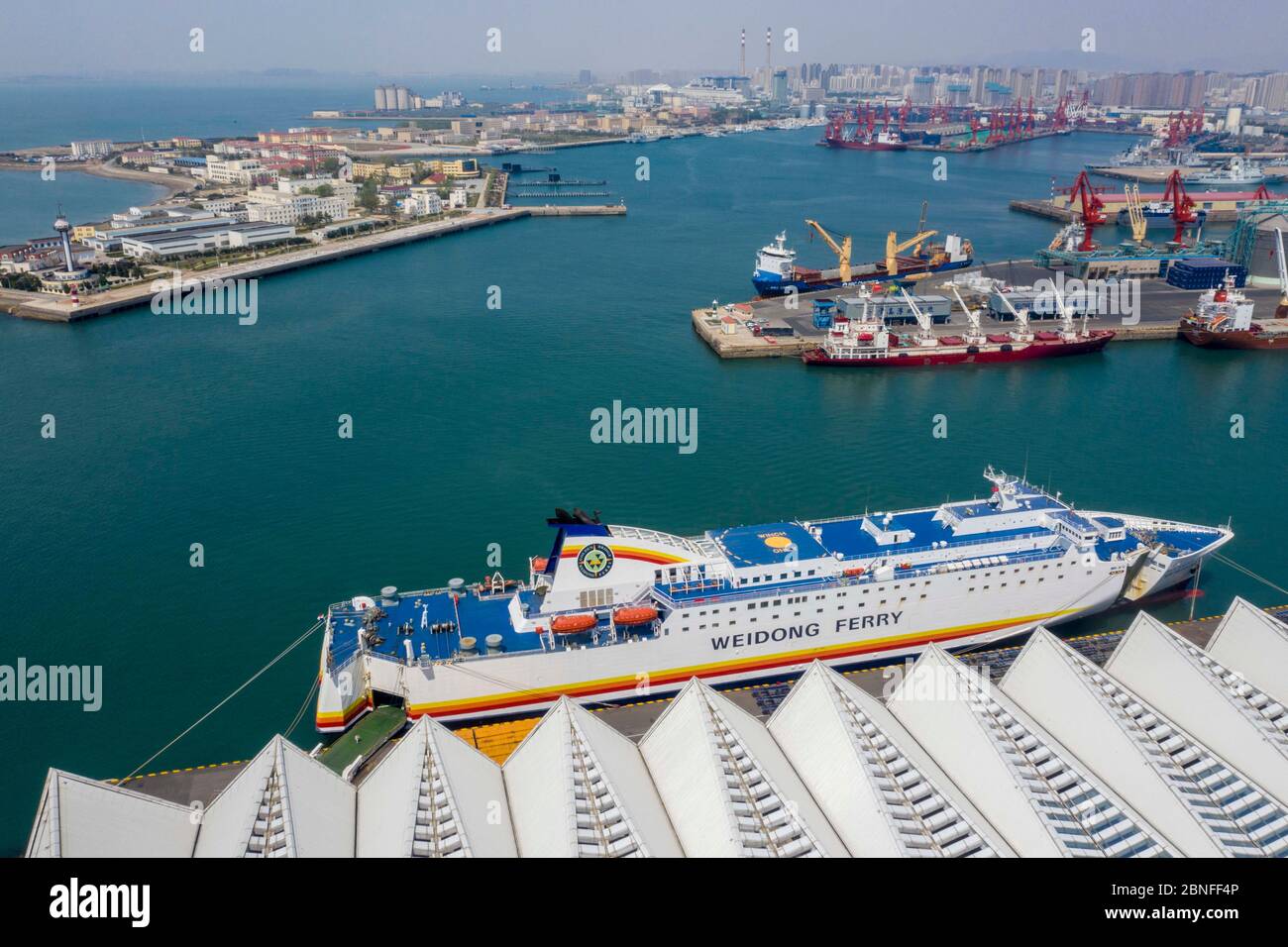 An aerial view of a cruise harboring at Qingdao Cruise Terminal ...