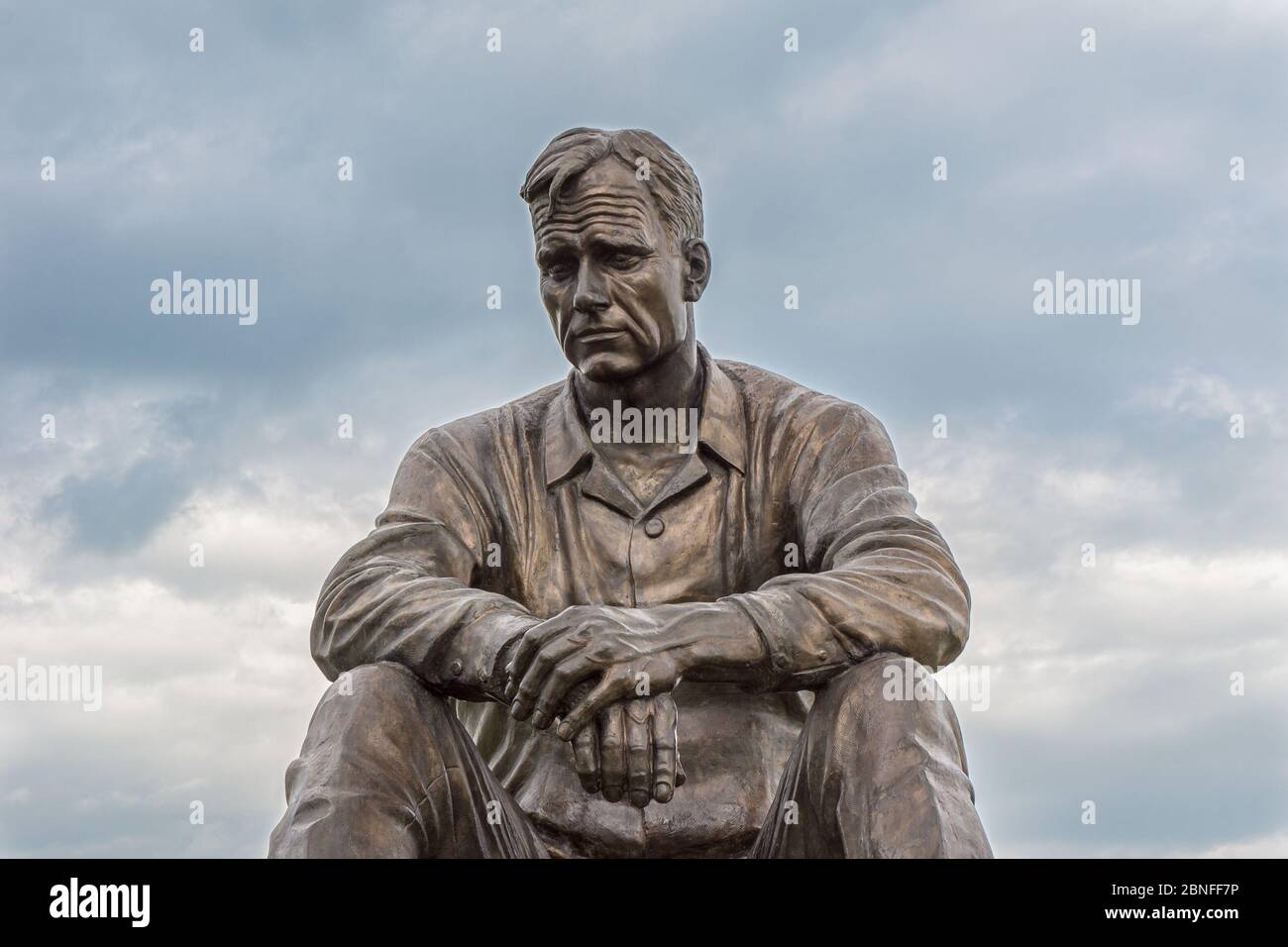 Altai, Russia - 2019, monument in the form of a man who sits on the ...