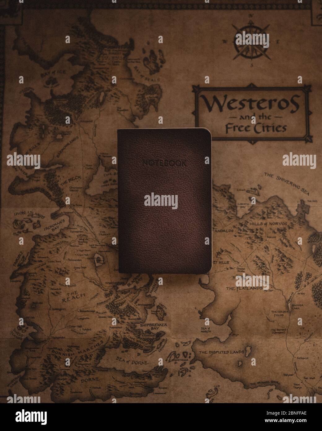 Vertical high angle shot of a leather notebook on a piece of an old map ...