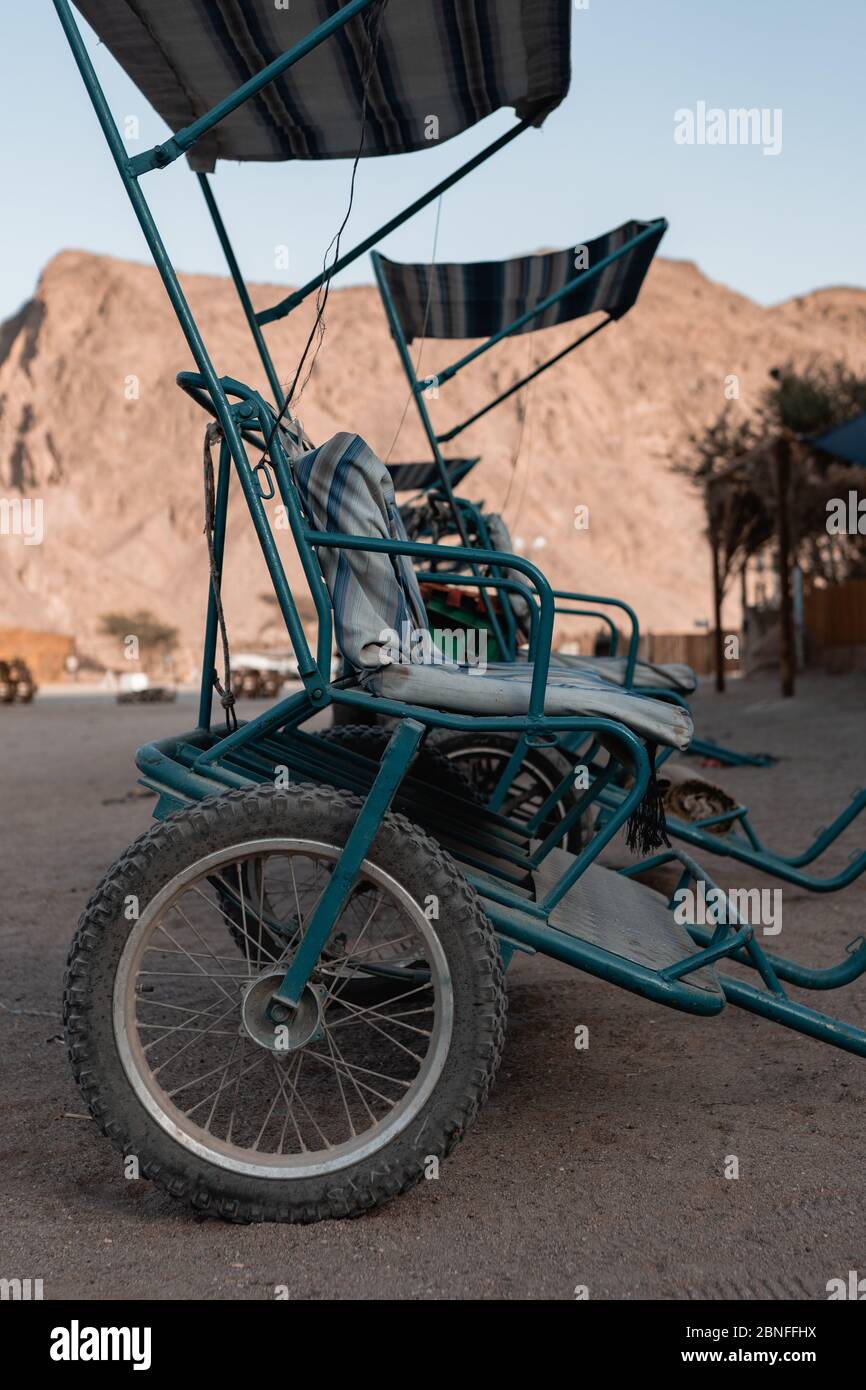 Vertical shot of the metal carriages near the tents and the stable on a ...