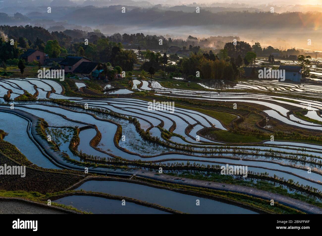 An aerial view of terraces on a hill near a small mountain village ...