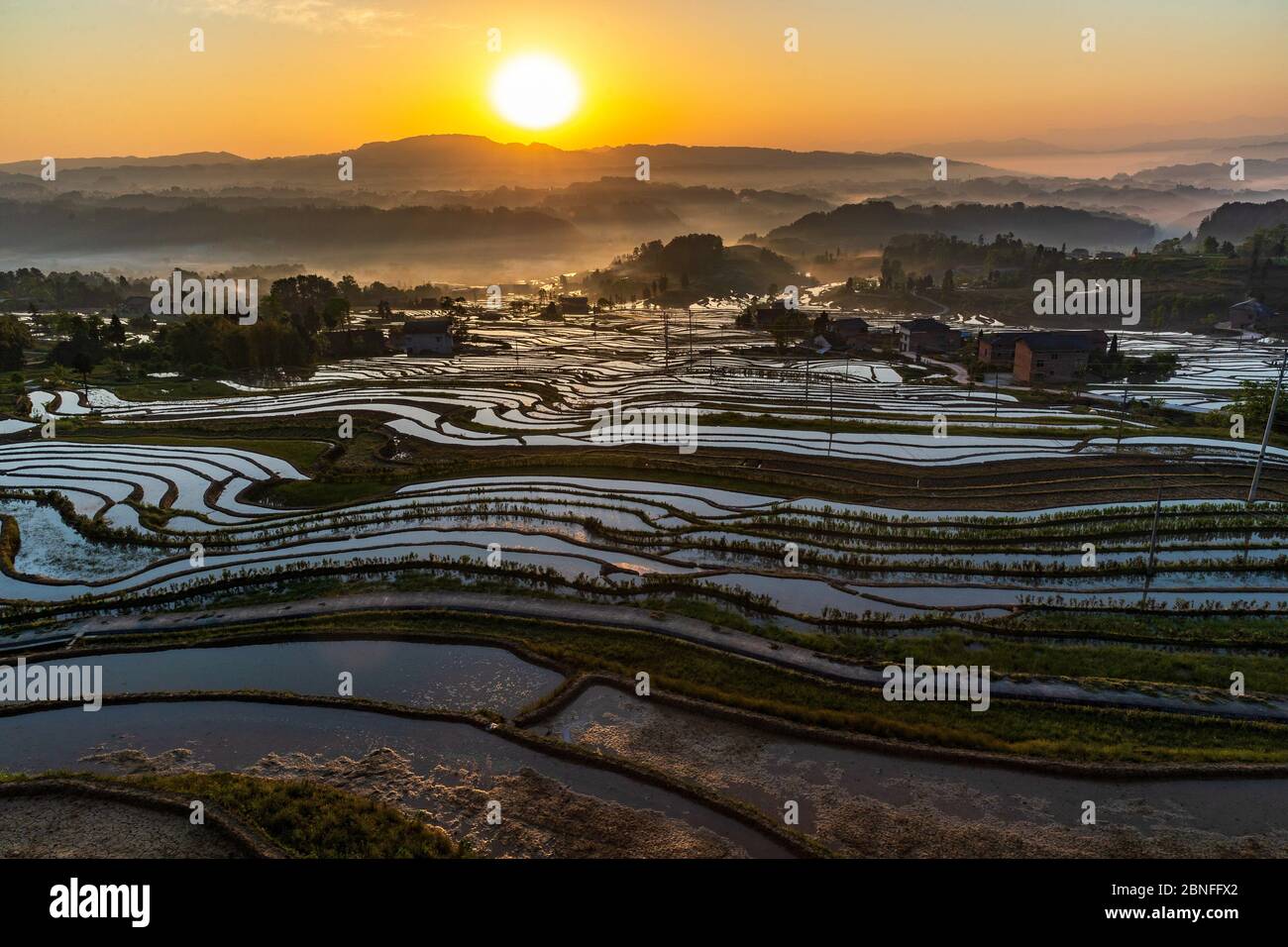 An aerial view of terraces on a hill near a small mountain village ...