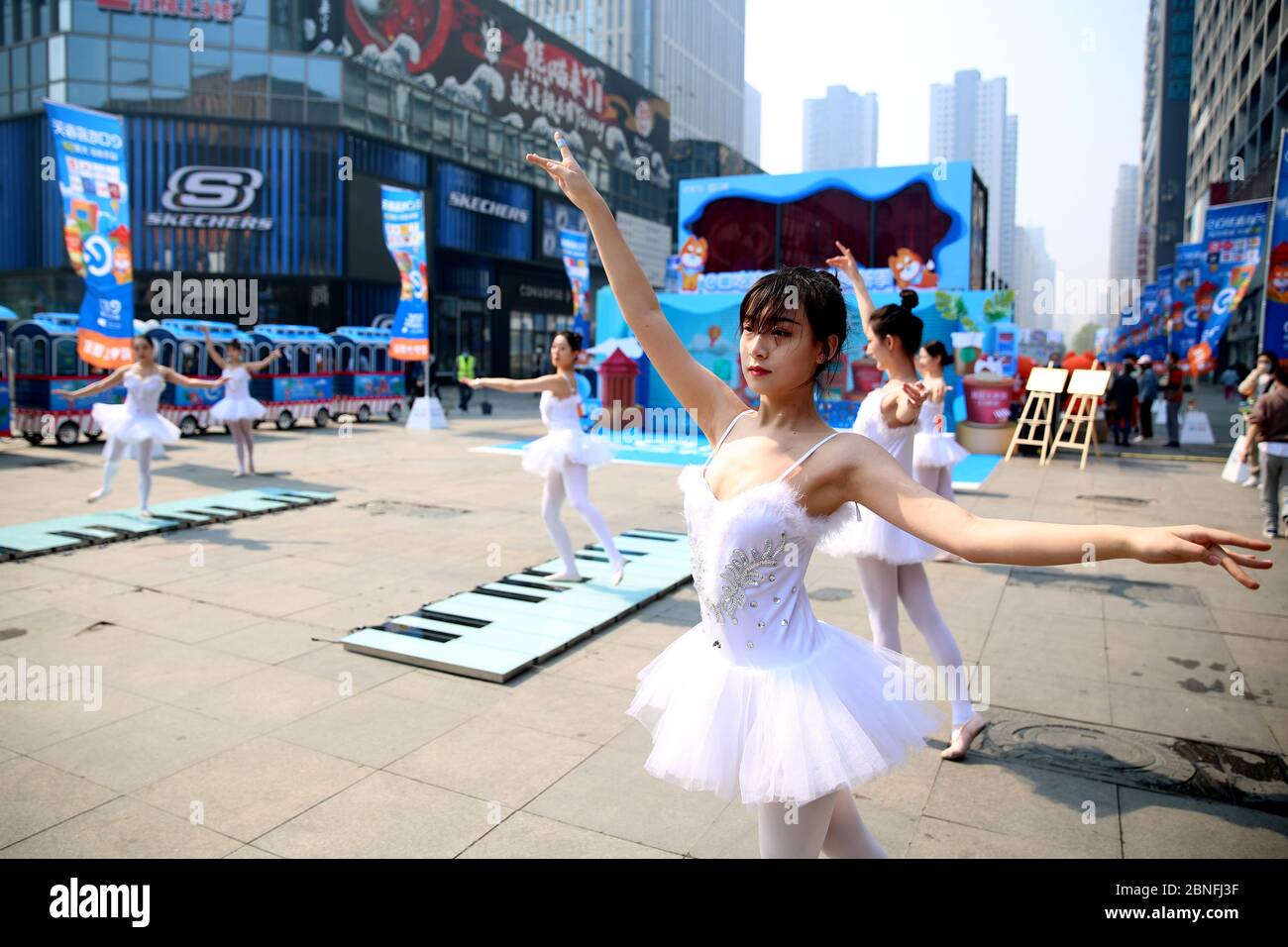Performers dance and show for the visitors during the promotional event ...