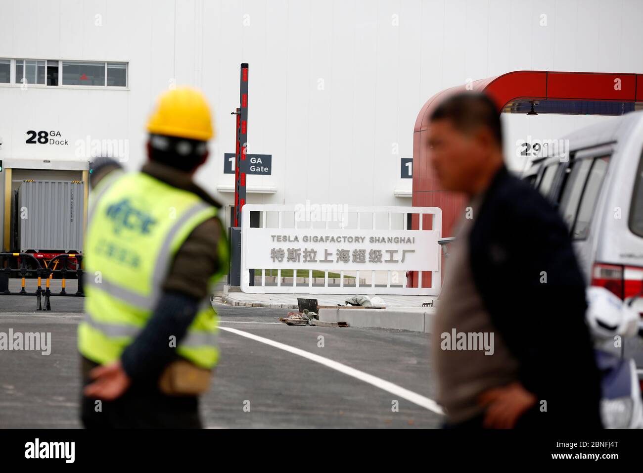 A security guard stands in front of the Tesla Gigafactory 3, which ...