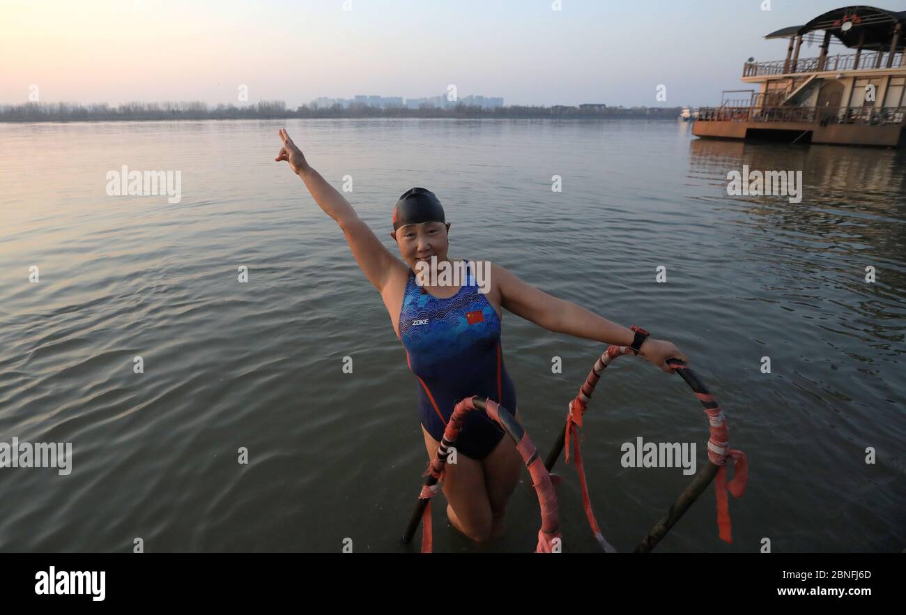 Three members of local winter swimming team do high diving at sunset ...
