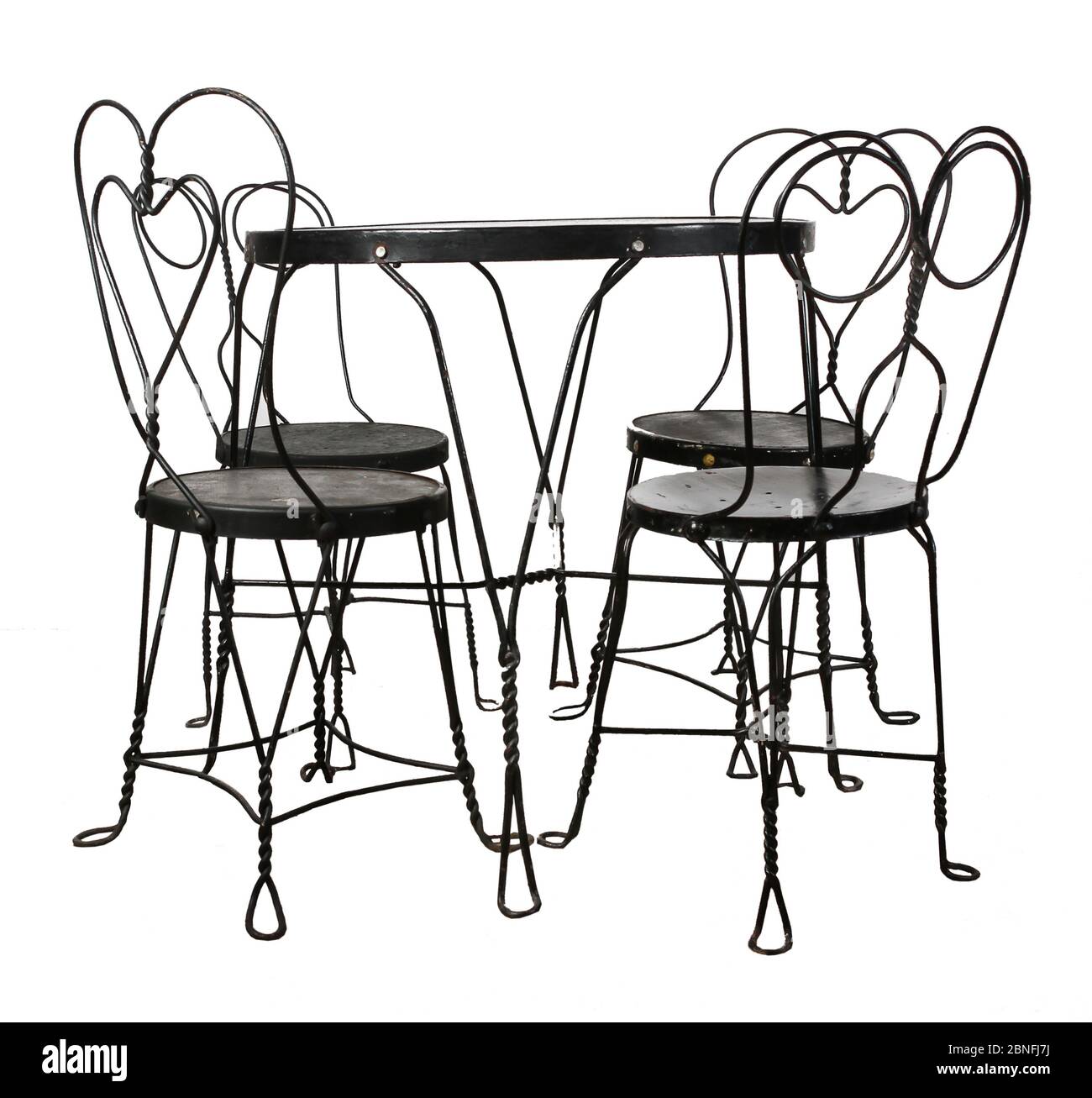 Black metallic table with chairs near it under the lights isolated on a ...