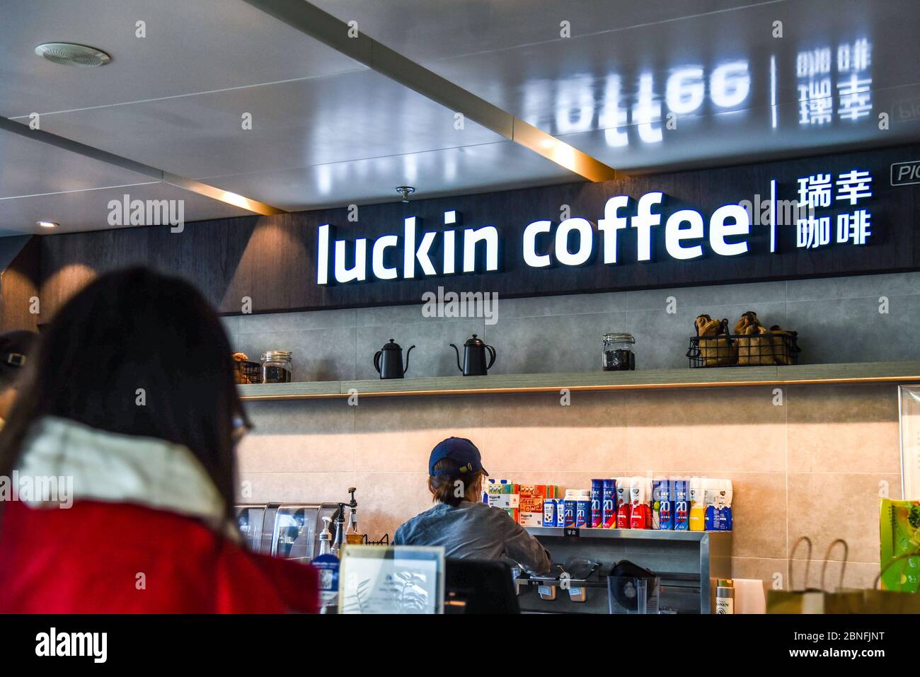 Cups of beverage and take-out coffee are lined on the counter waiting ...