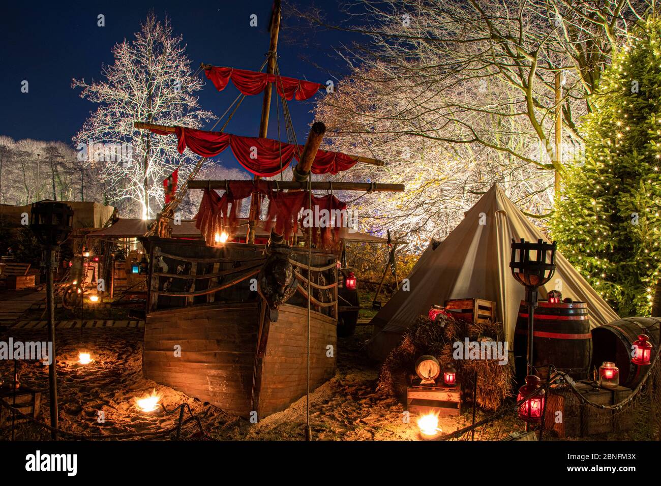 Horizontal shot of a decoration of brown ship with red sails on a brown ...