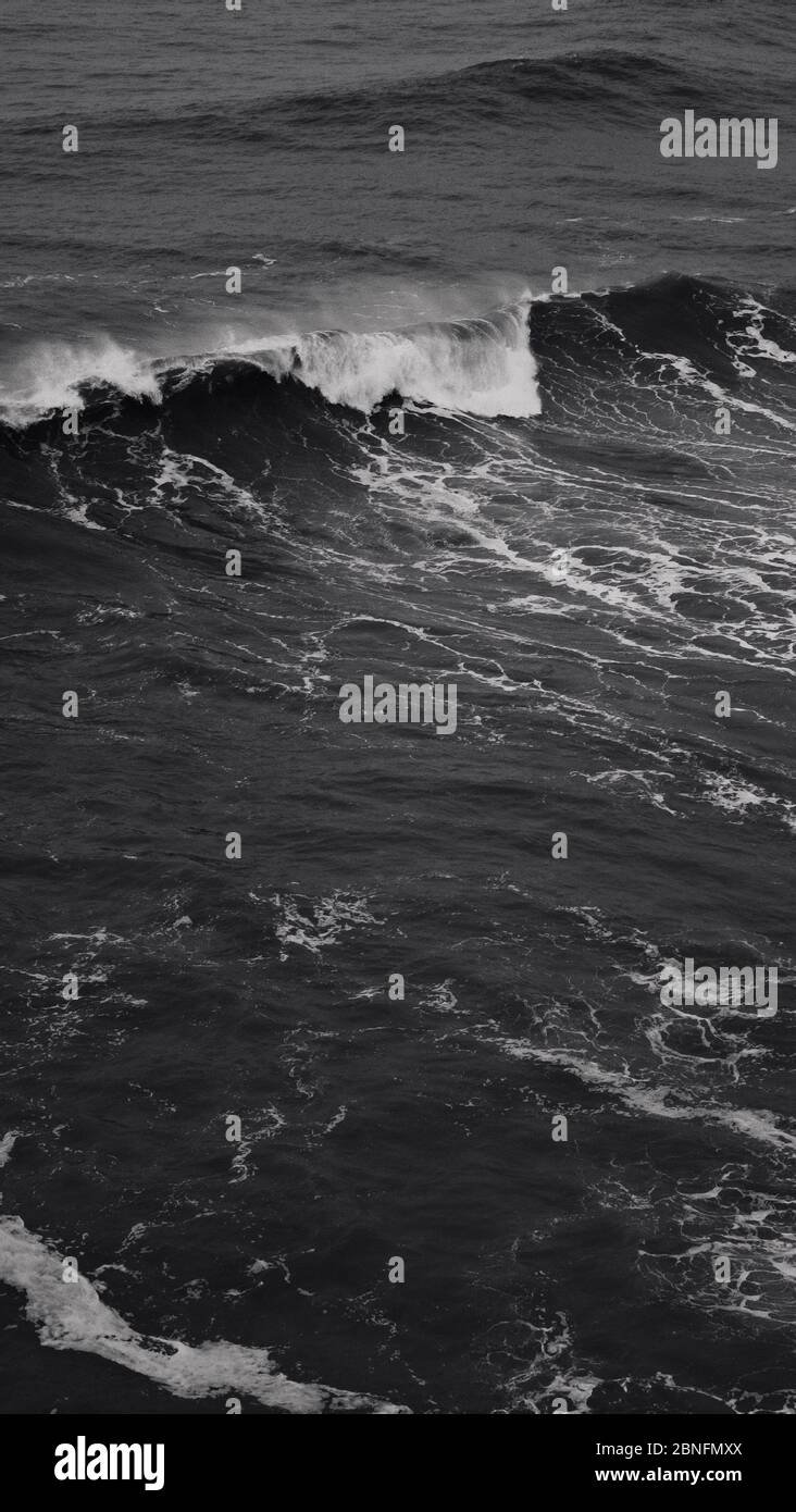 Vertical grayscale shot of a big wave breaking Stock Photo - Alamy