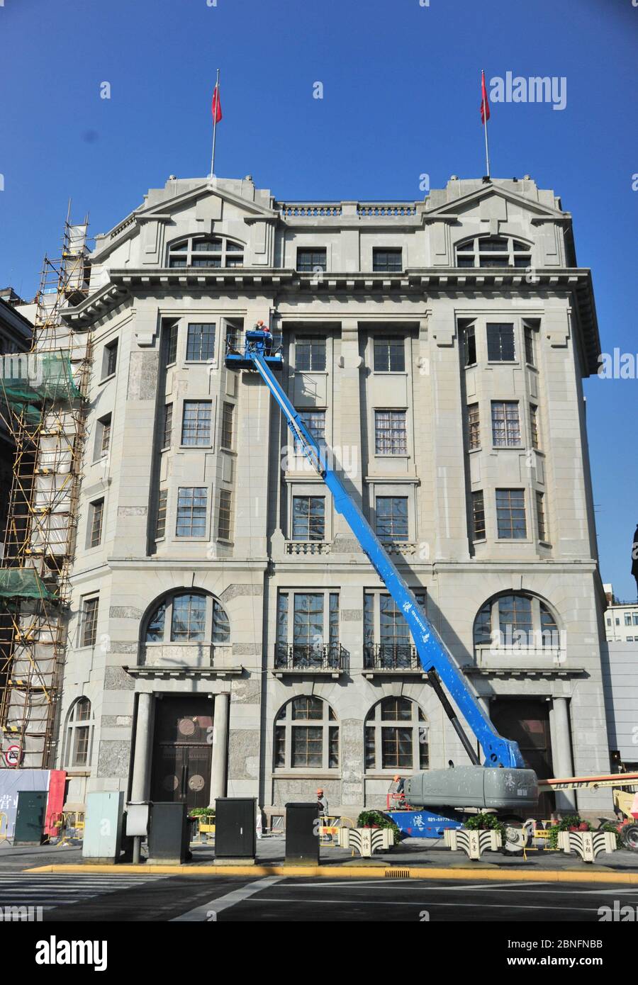 Workers are busy at renovating an old building, which belongs to the ...