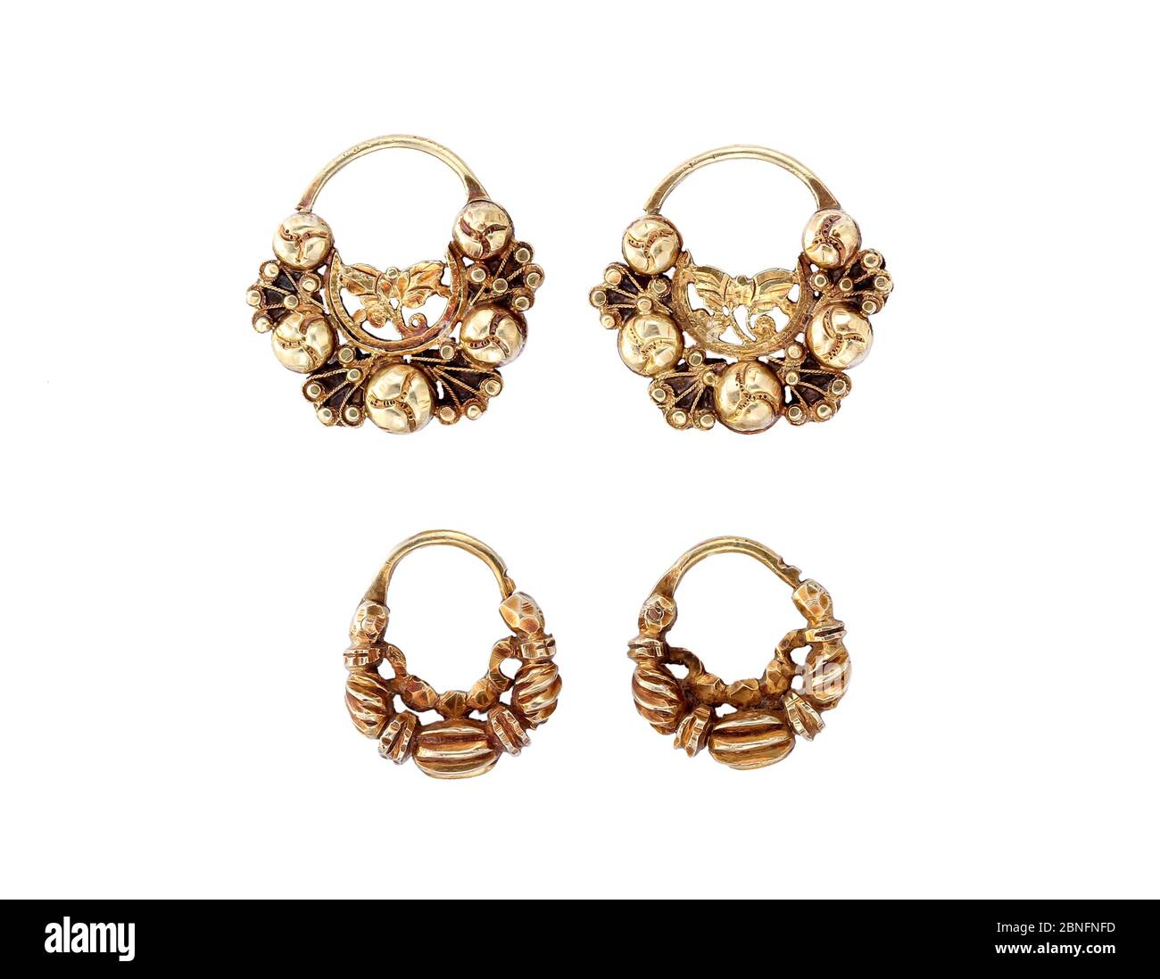 Closeup shot of an elegant golden four rings isolated on a white ...