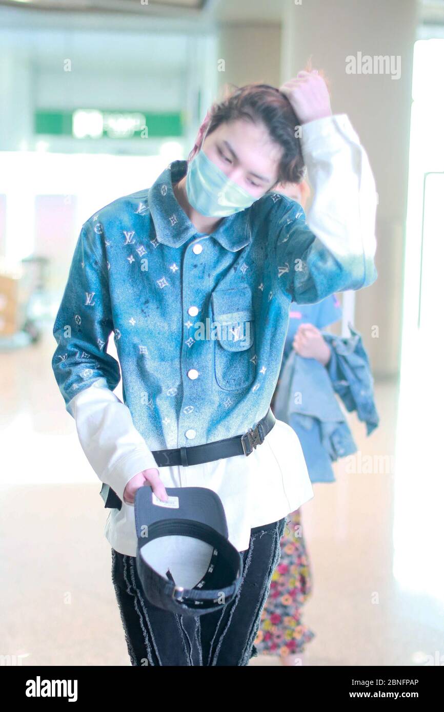 Chinese singer Ling Chao arrives at a Beijing airport before departure ...