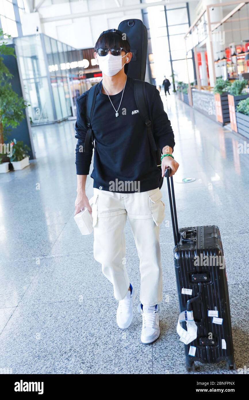 Chinese actor Fan Jinwei shows up at a train station before departure ...