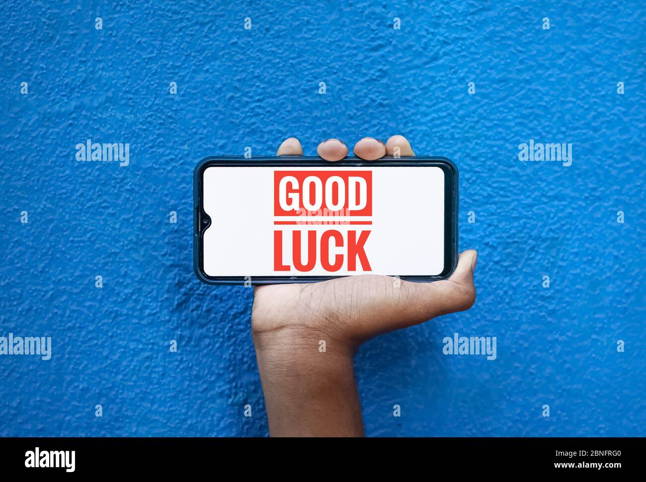 Good luck wording on smart phone screen isolated on blue background ...