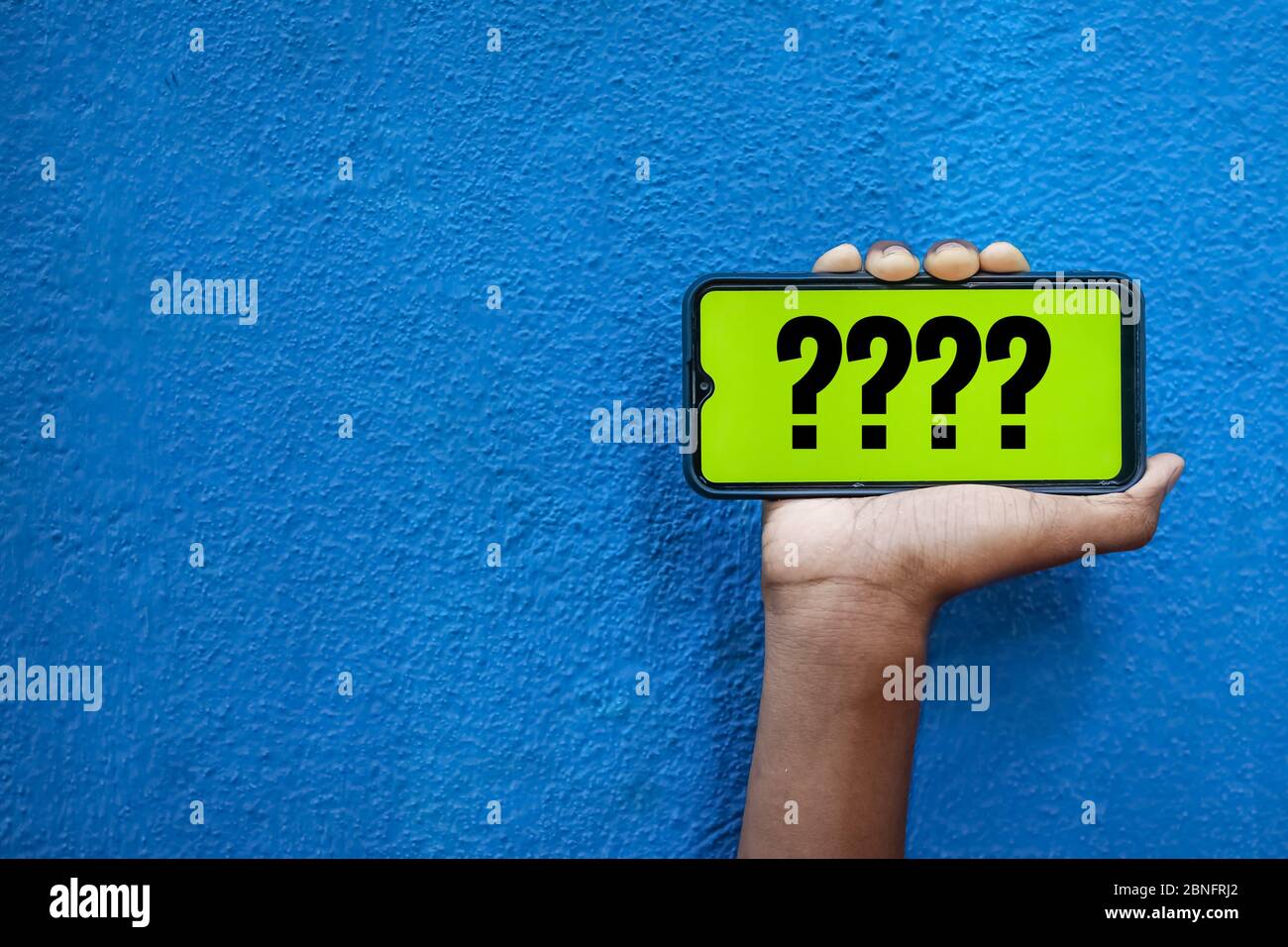 Question mark wording on smart phone screen isolated on blue background ...