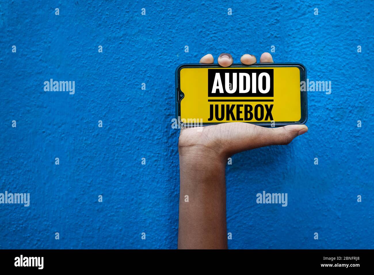 Audio jukebox word on smart phone screen isolated on blue background ...
