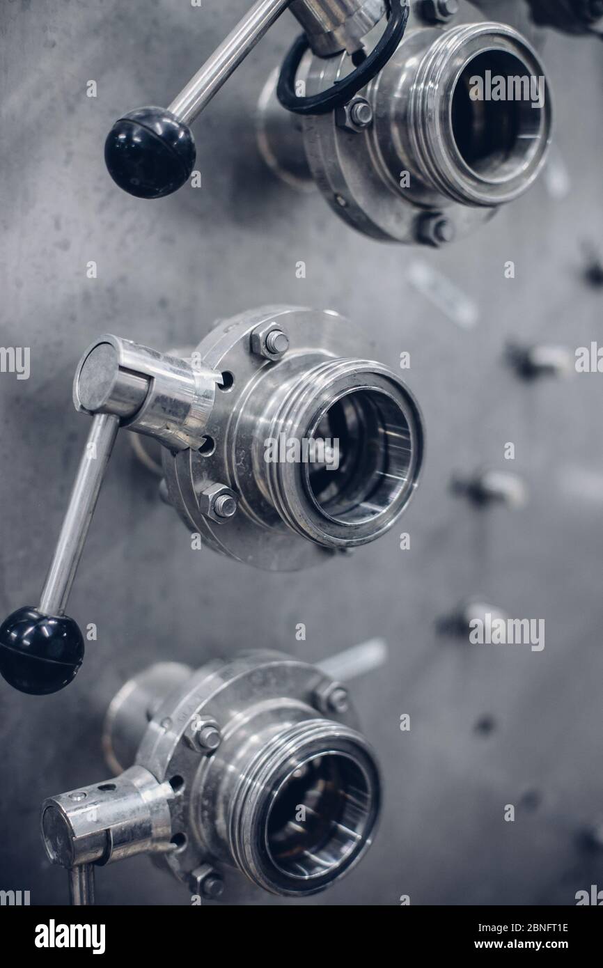 Vertical grayscale selective focus shot of stainless steel machine ...