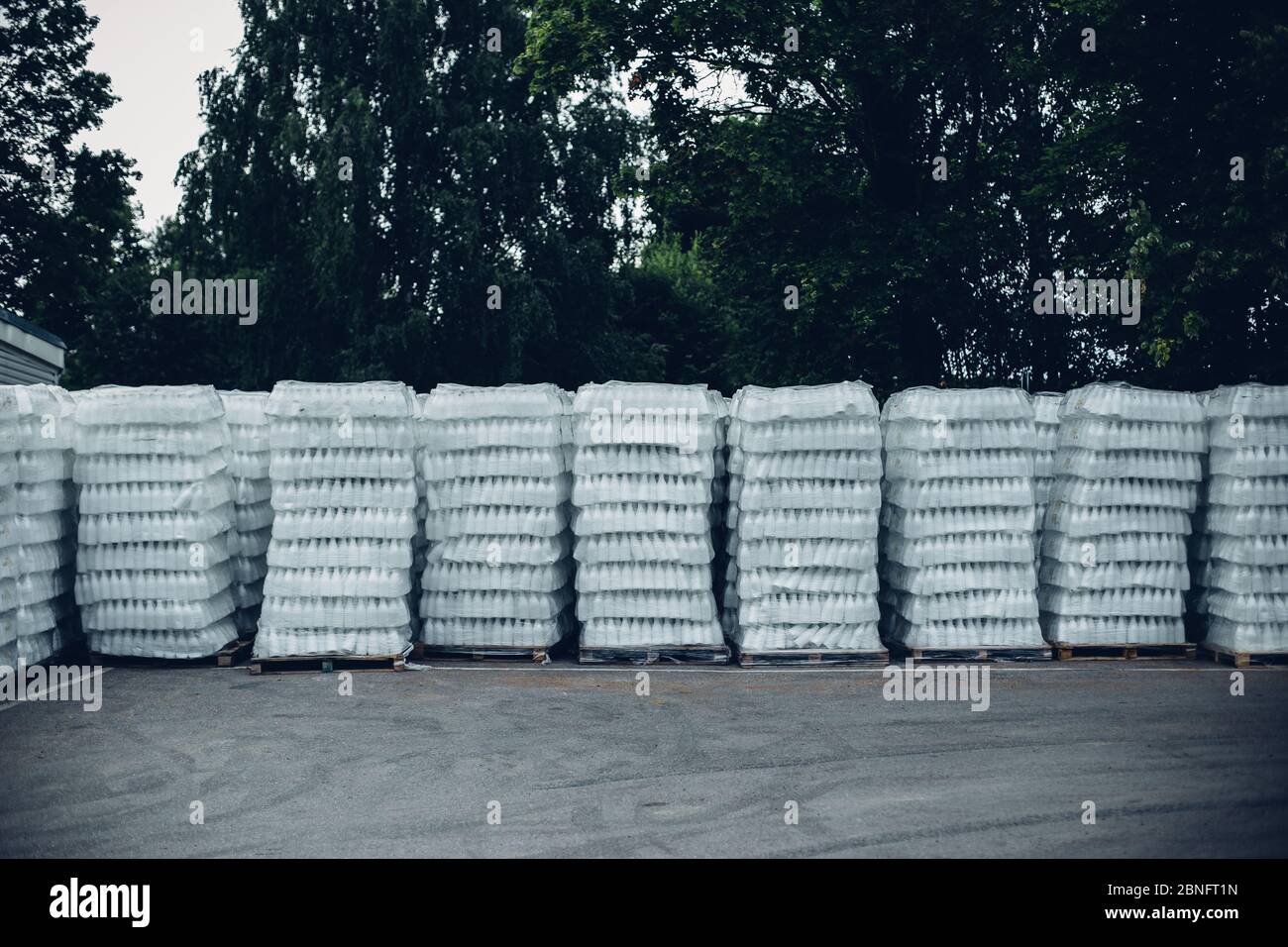 Horizontal shot of piles of complete milk bottle packages with outdoor ...