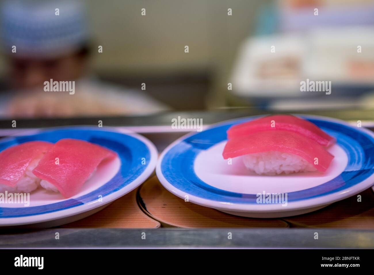 Sushi on conveyor belt in a Japan restaurant. Traditional Kaitenzushi ...