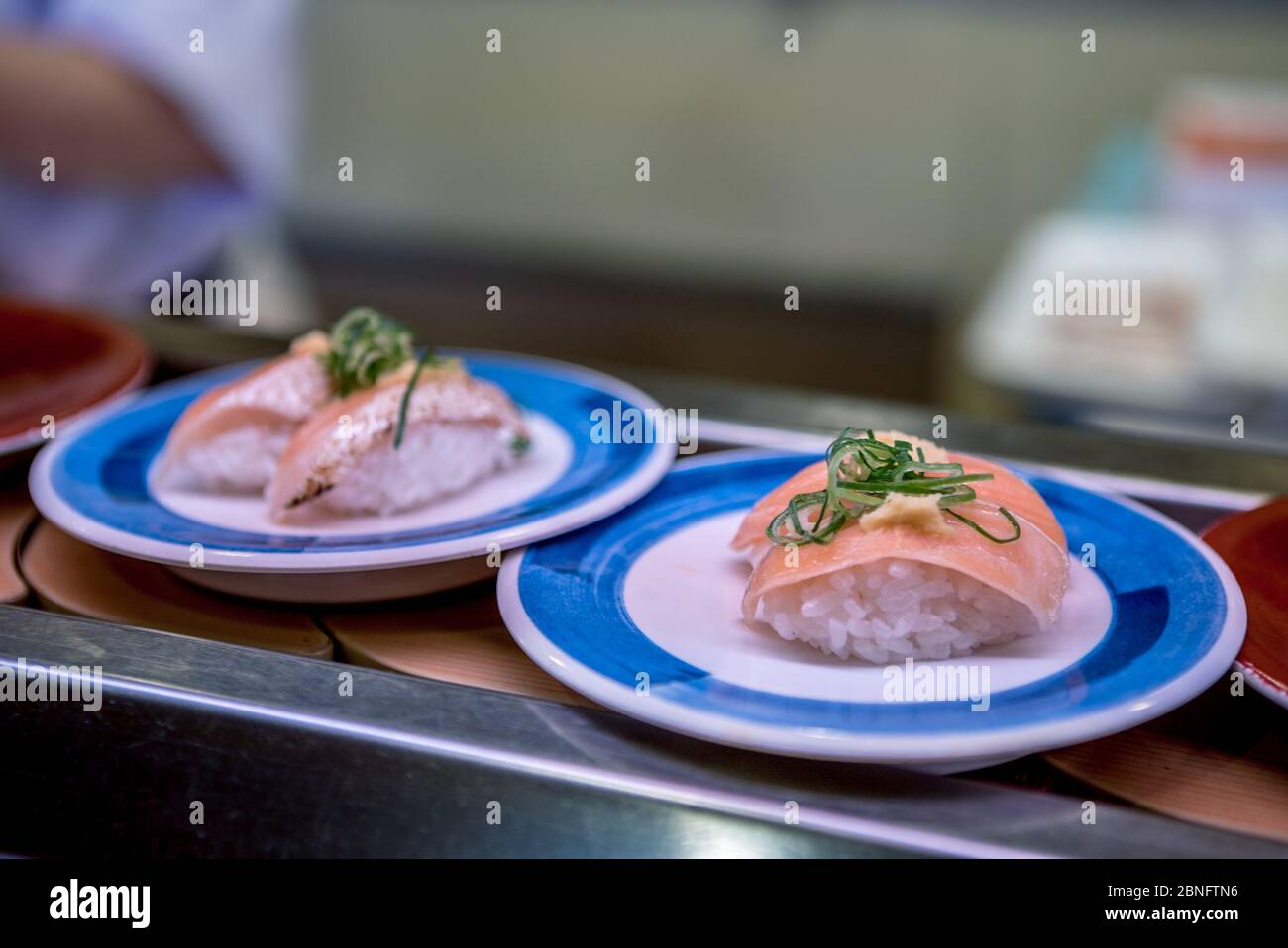Sushi on conveyor belt in a Japan restaurant. Traditional Kaitenzushi ...