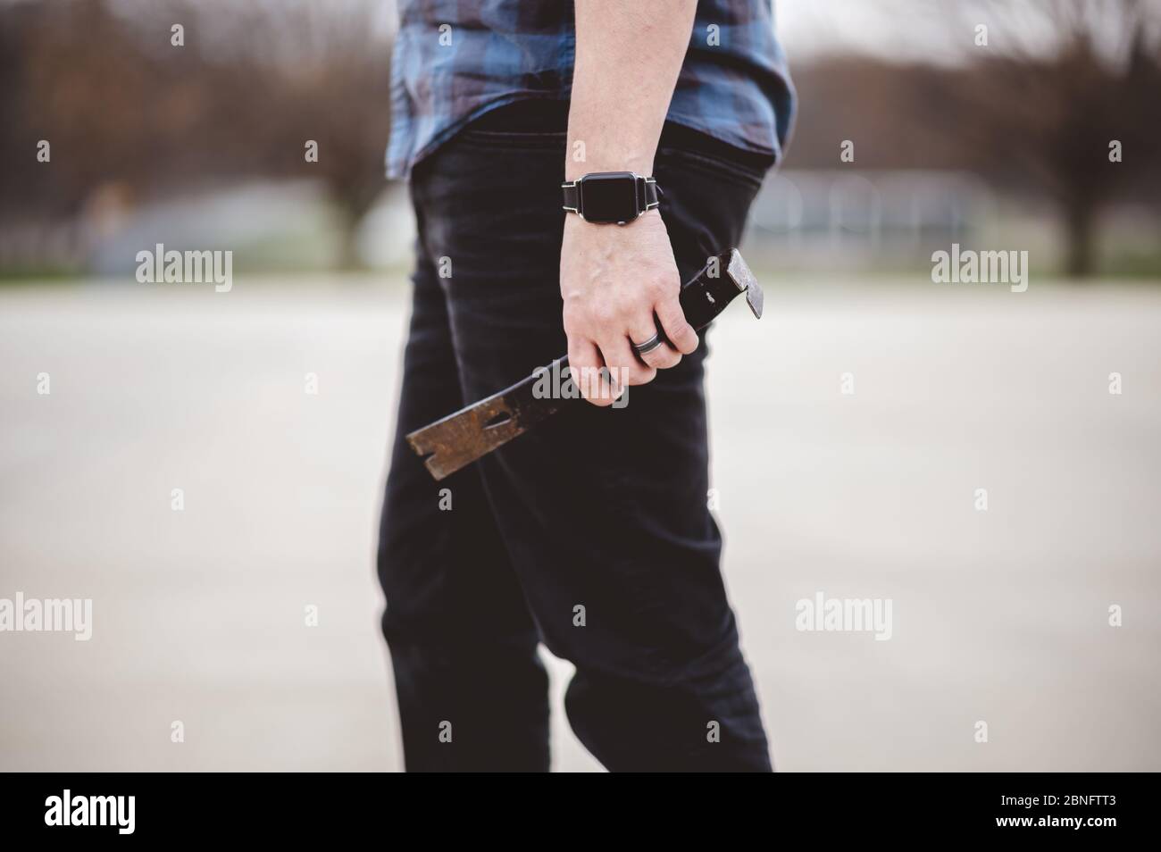 Man holding a crowbar Stock Photo - Alamy