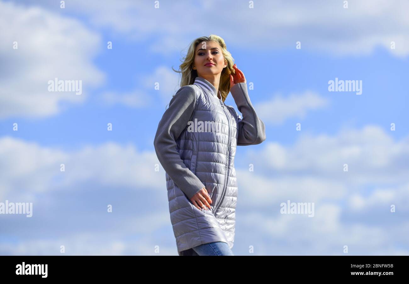 Windy day. Girl jacket cloudy sky background. Woman fashion model ...