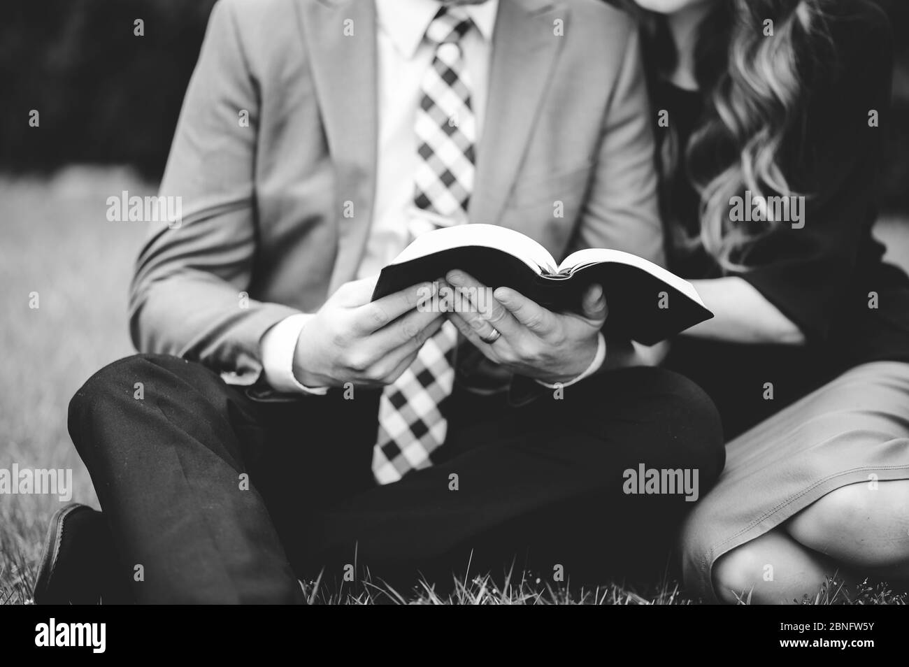 Greyscale shot of a male and a female wearing formal clothes while ...