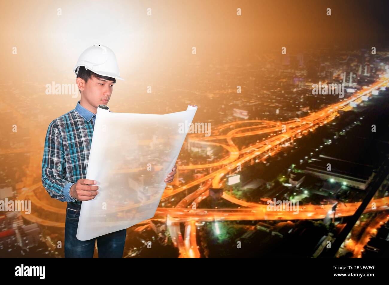 Engineer open hold blueprints in construction concept with night ...
