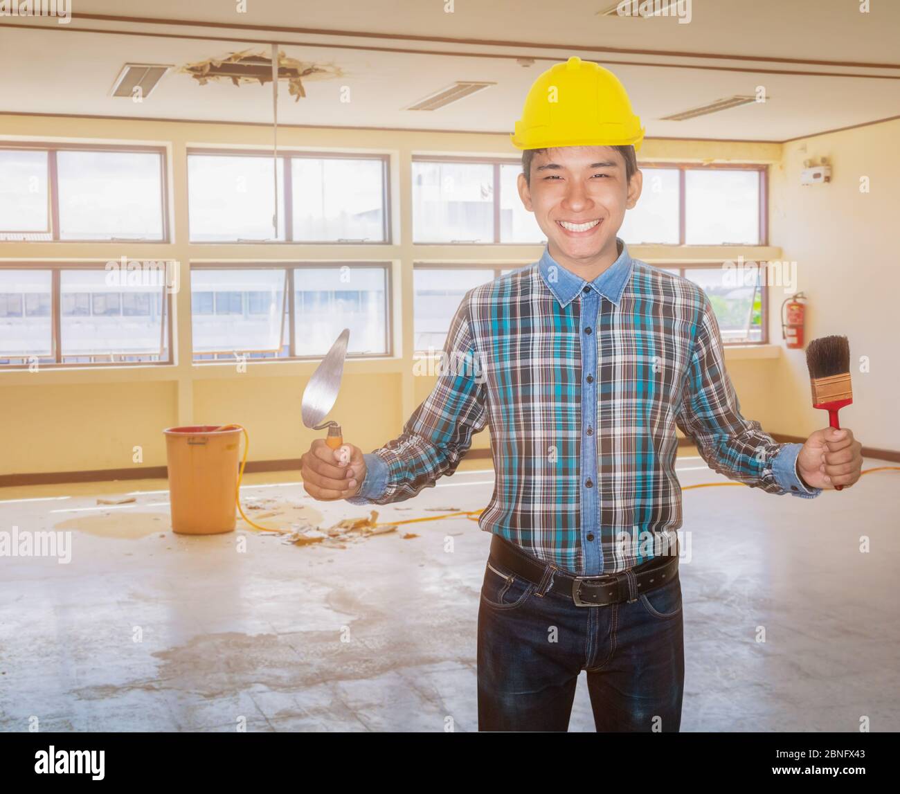 engineer smile with hand holding triangle trowel and paint brush. in ...