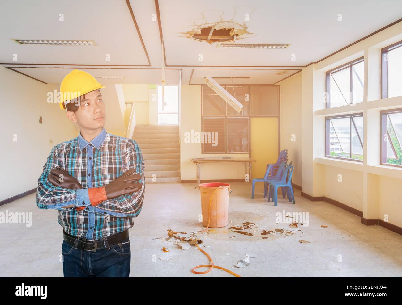 water leak drop interior office building in red bucket from gypsum ...