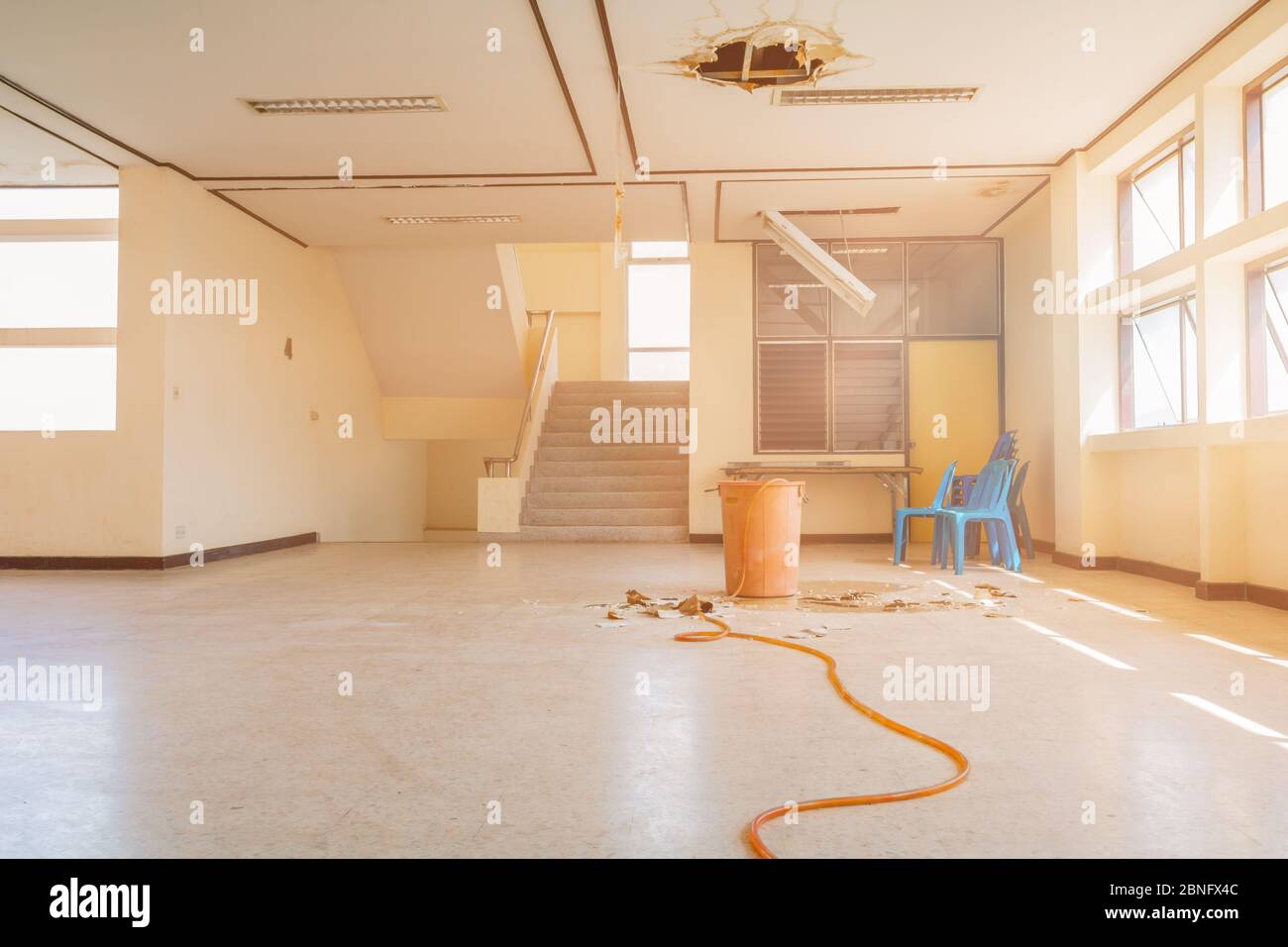 water leak drop interior office building in red bucket from gypsum ...