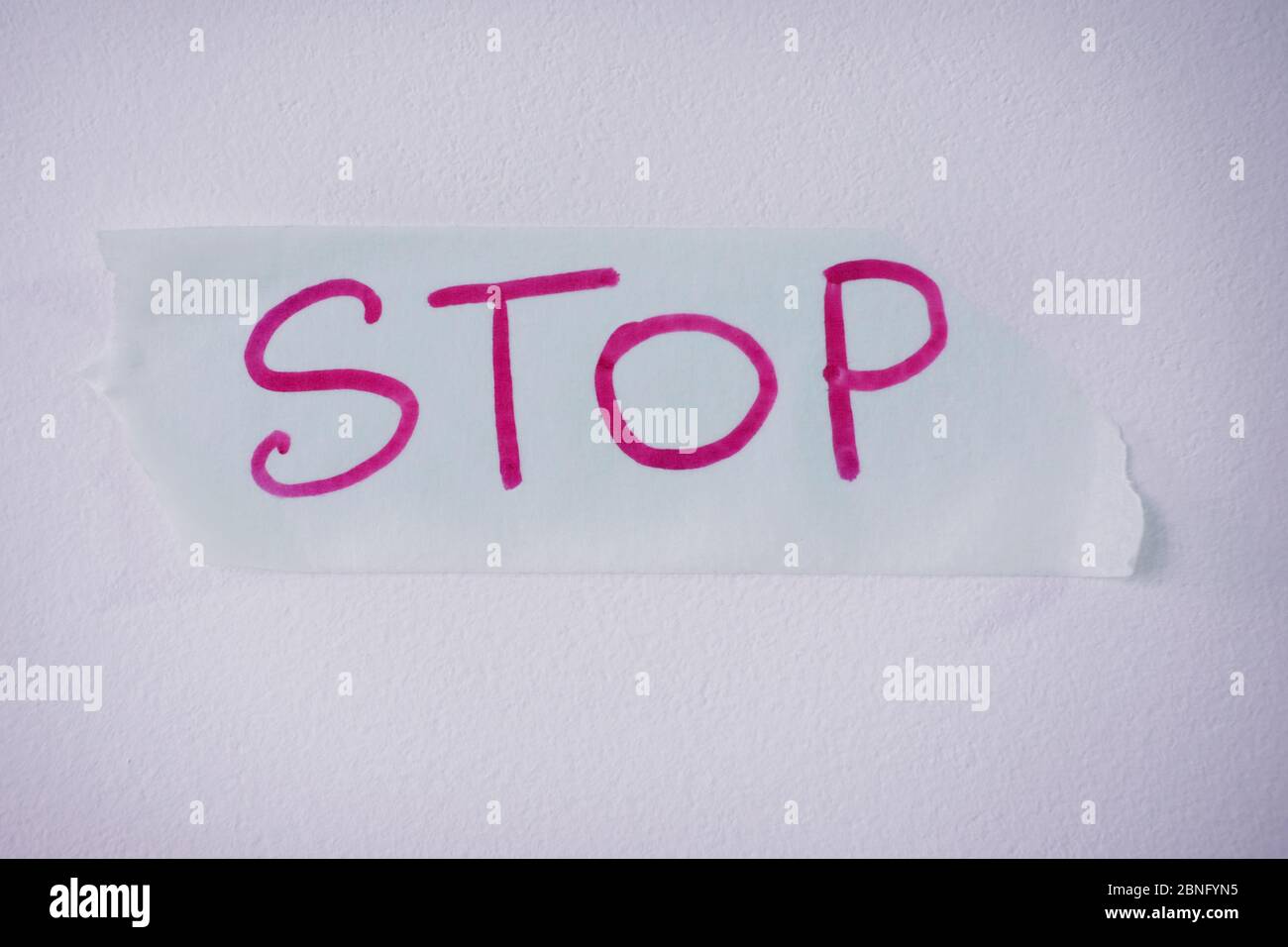 Word "stop" in red written on a white piece of paper Stock Photo - Alamy