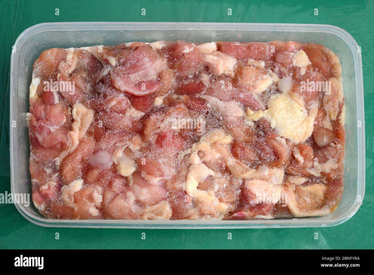 Raw frozen chicken in plastic box Stock Photo - Alamy