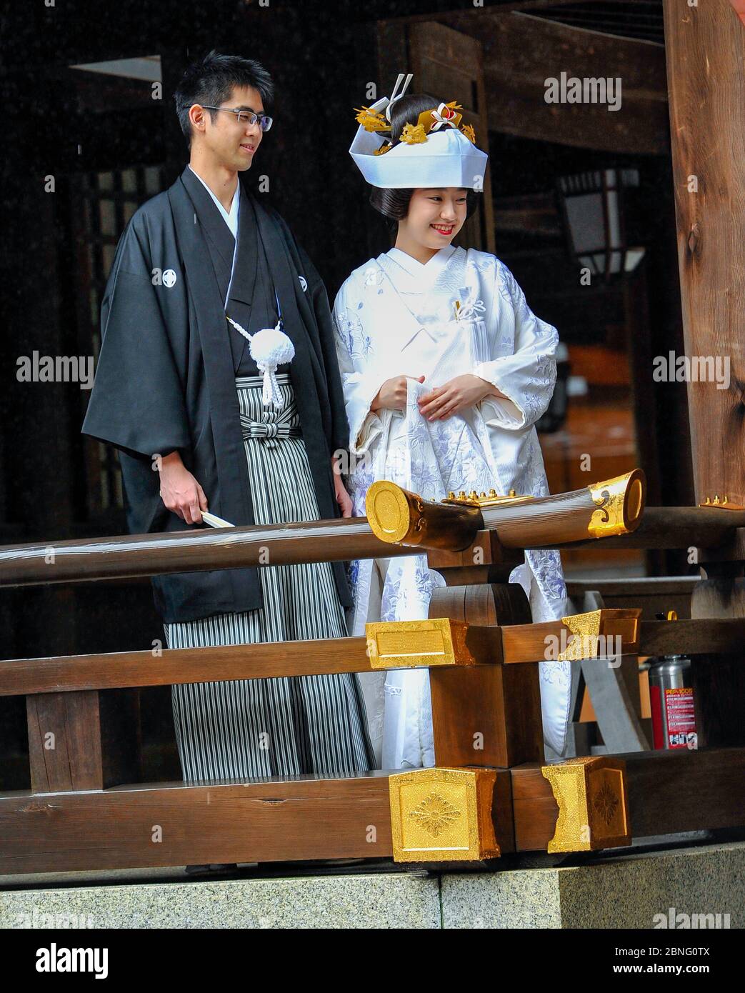 Bride and groom taking wedding photos at the Meiji Shrine in Tokyo ...