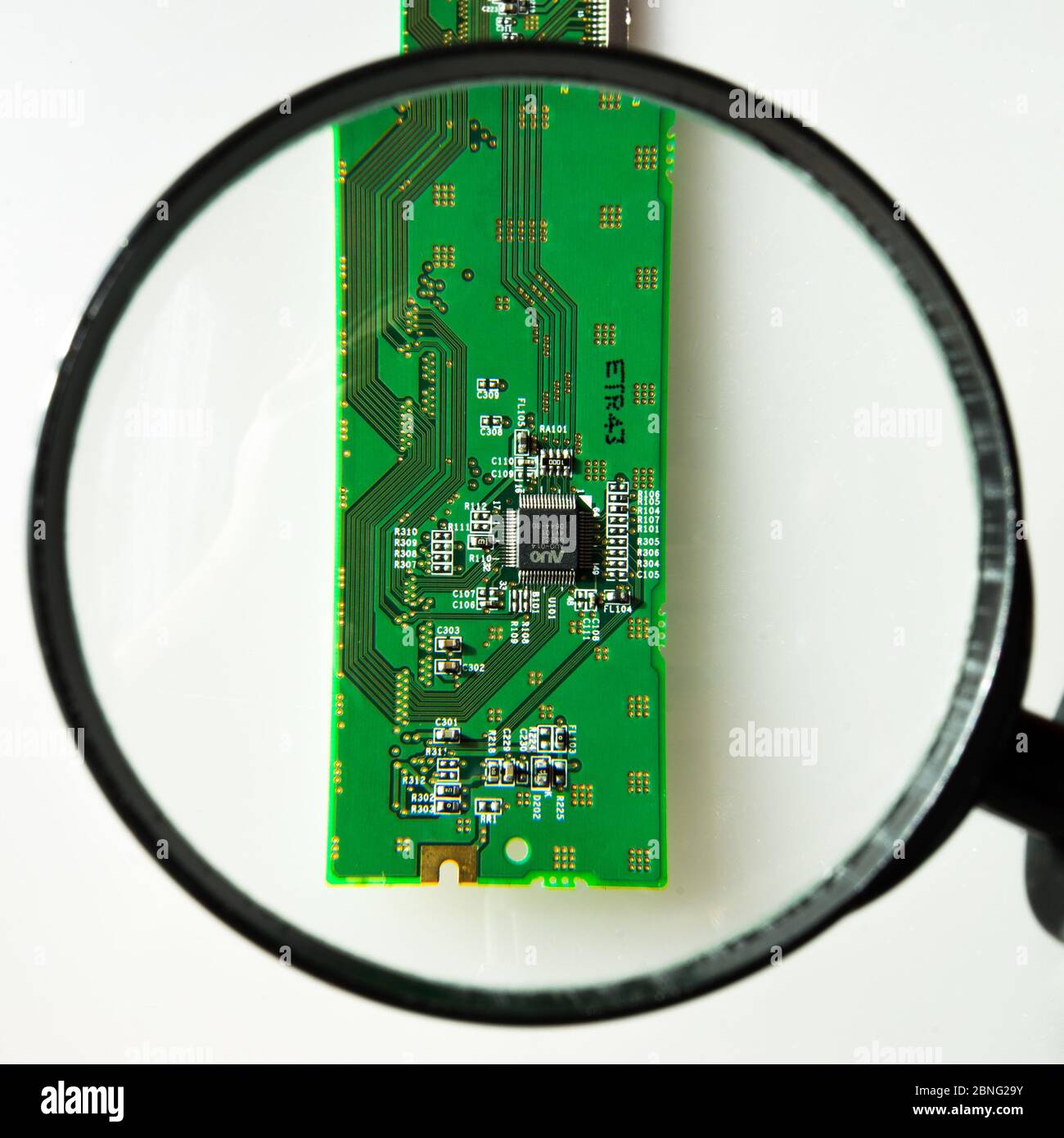Engineer looking at a circuit board through a magnifying glass Stock ...