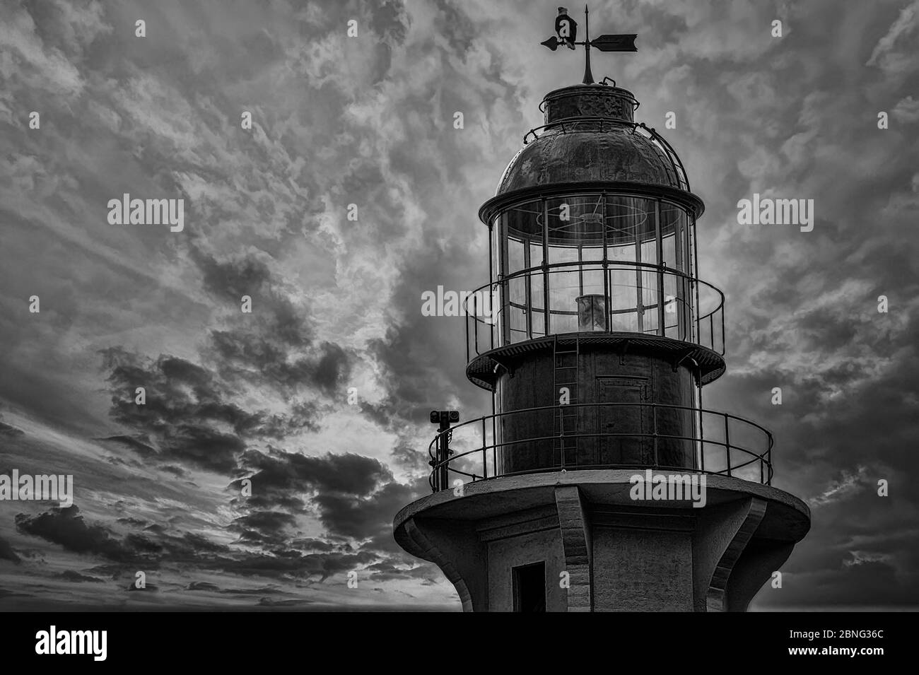 Greyscale shot of a lighthouse with an eagle on its top Stock Photo - Alamy