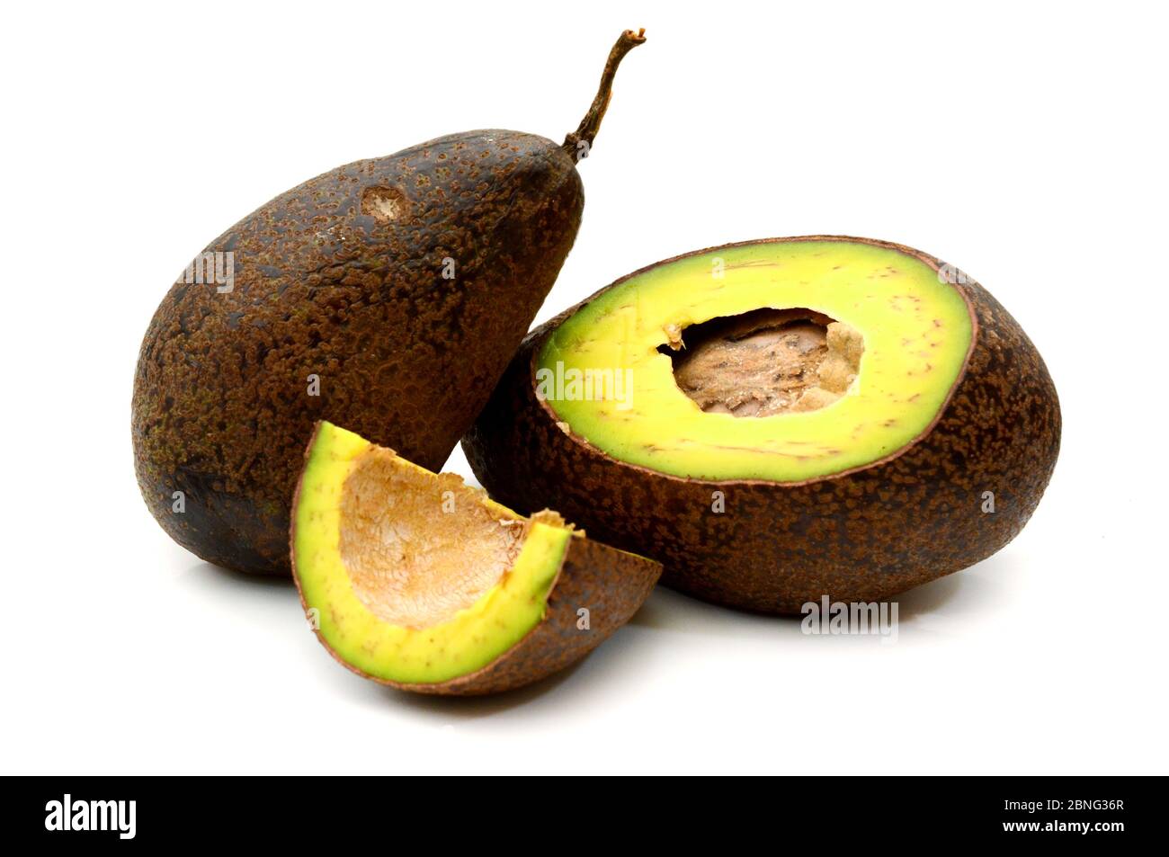 Fresh Avocados two whole and one halved isolated on white Stock Photo ...