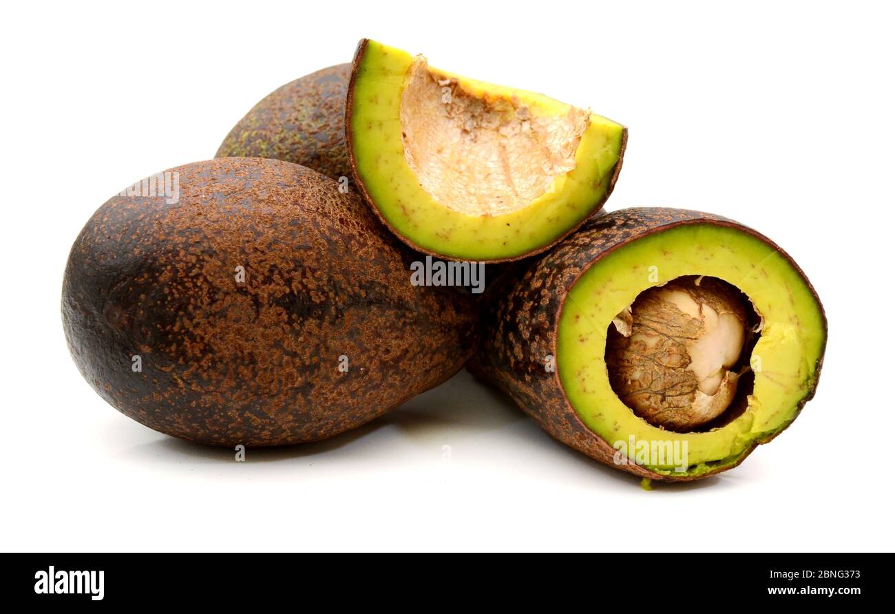 Fresh Avocados two whole and one halved isolated on white Stock Photo ...
